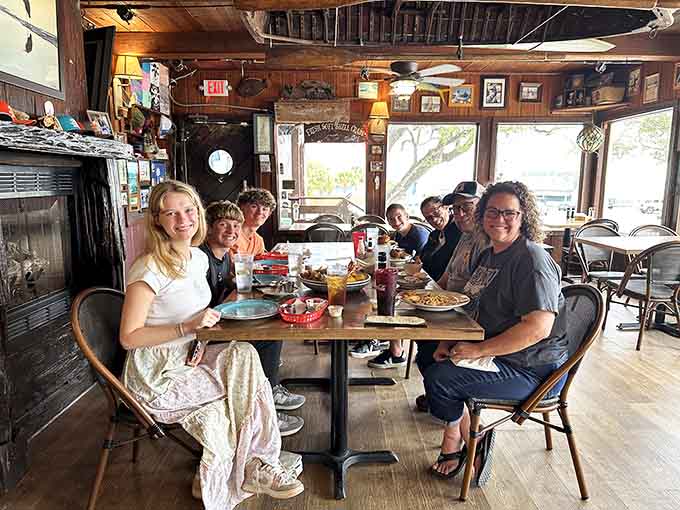 Happy diners gathered around the table, sharing a meal and making memories in this cozy waterfront spot together.