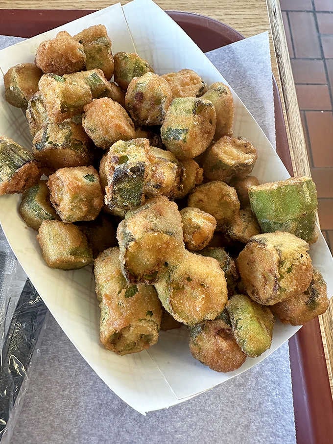 Fried okra pieces tumbling over each other like golden nuggets, crispy outside and tender inside, absolutely addictive stuff here.