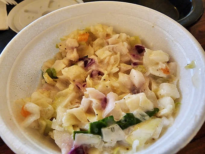 Creamy coleslaw in a cup, providing that cool, crunchy contrast your fried seafood basket desperately needs for balance.