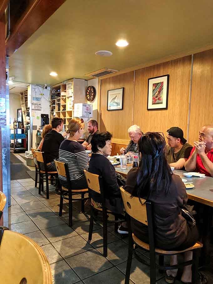 The communal dining experience brings strangers together over shared love of exceptional, fresh sushi.