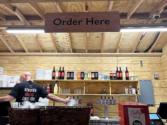 Behind the counter, skilled hands work with practiced efficiency to feed the devoted masses.