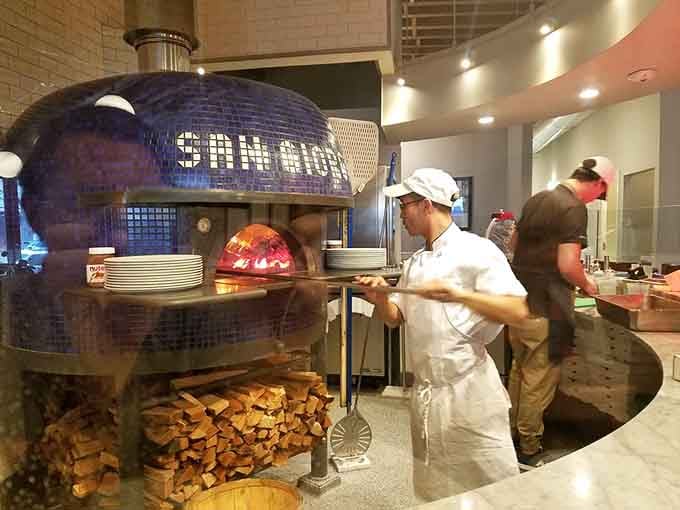 That glowing Stefano Ferrara oven reaches 900 degrees, turning out perfect pies in just 90 seconds flat.