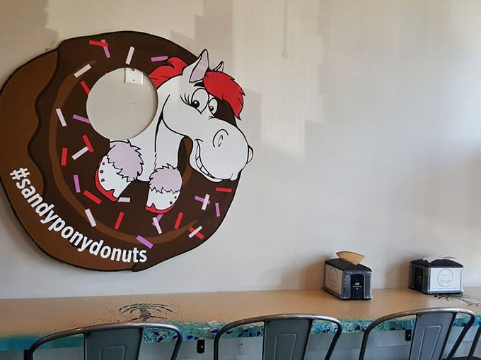 Cozy seating with a cheerful pony mascot watching over your donut consumption with obvious approval.