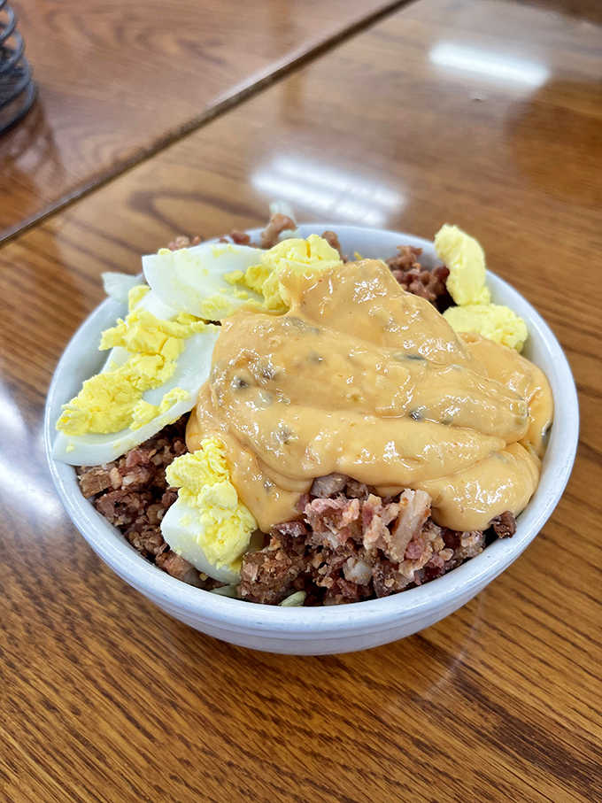 Corned beef hash topped with eggs and gravy, proving breakfast can be an art form.