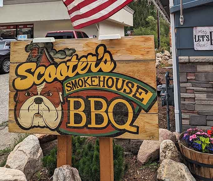 Hand-painted signage featuring that friendly bear logo, guiding hungry travelers to their delicious destination with unmistakable mountain charm and character.