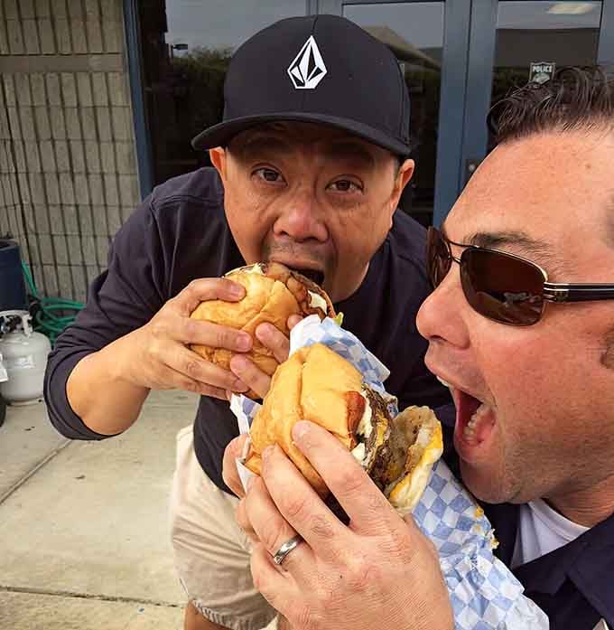 The moment of truth captured perfectly as two friends attempt to wrap their mouths around pure joy.