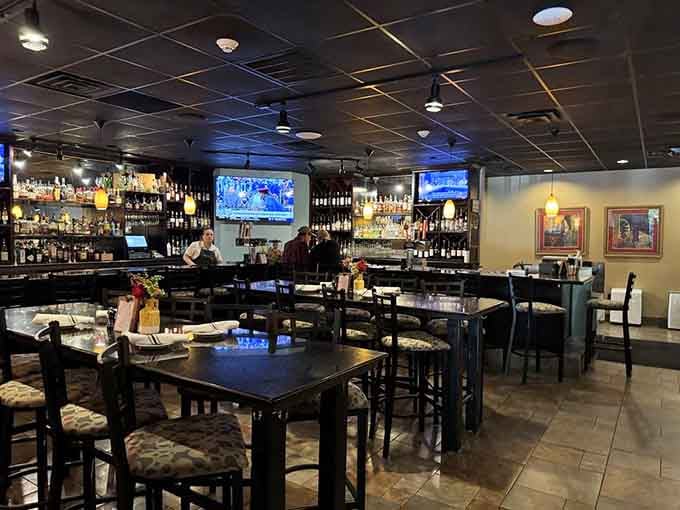 The bar area beckons with its impressive selection, ready to pour whatever helps you unwind after a long day.