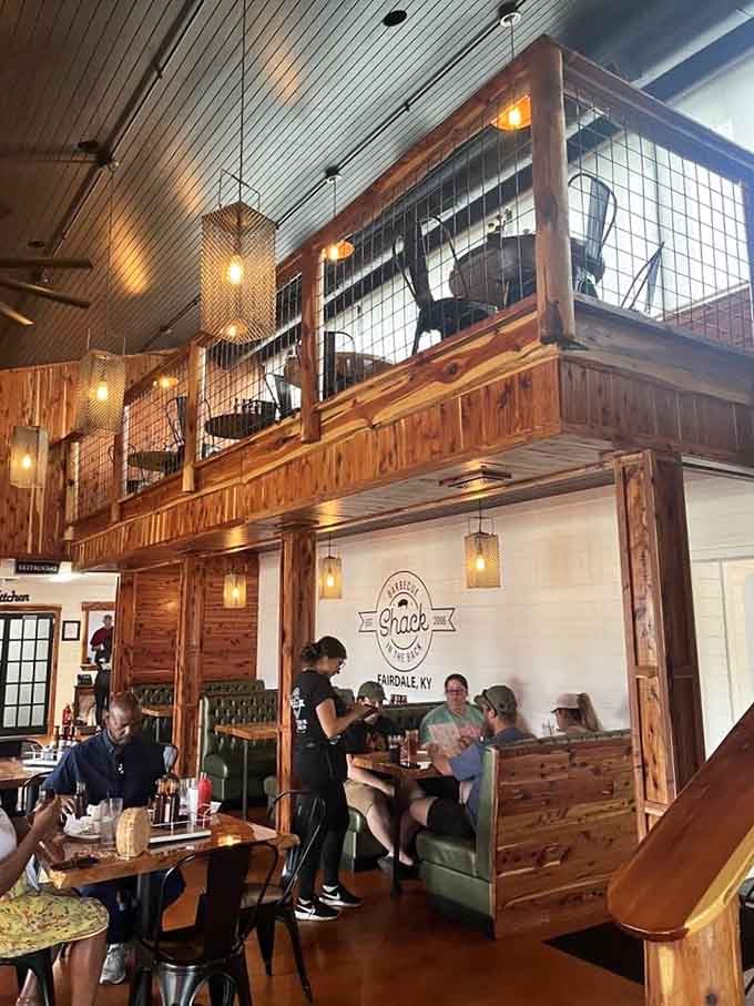 Two-story seating with green booths and wooden tables means there's always room for one more hungry customer.