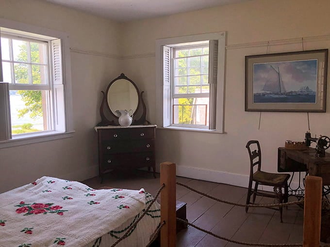 Simple bedroom furnishings reveal the modest comforts of lighthouse life, where ocean views compensated for lack of modern amenities.