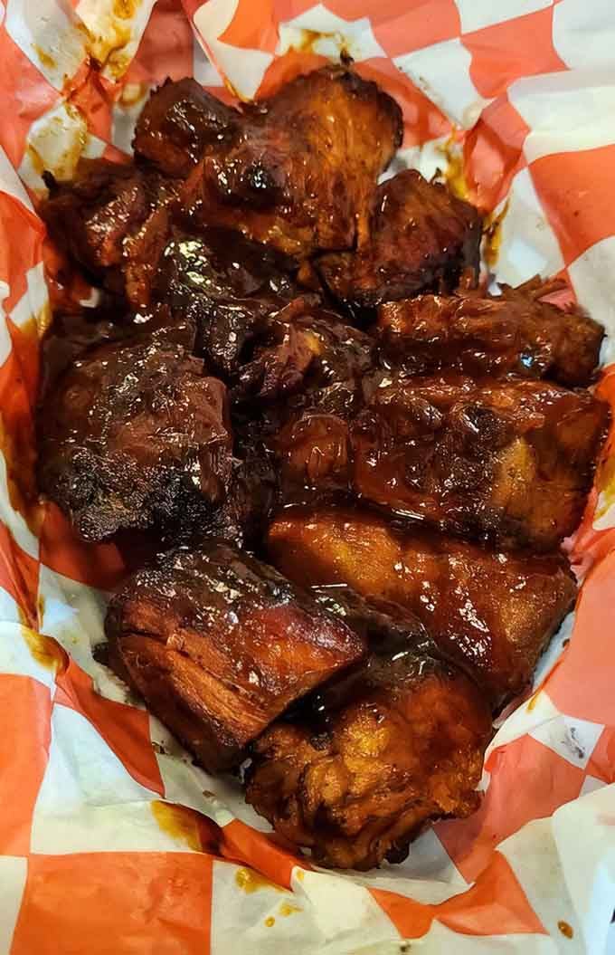Burnt ends glistening in sauce are the crispy, caramelized nuggets of pure barbecue heaven you crave.