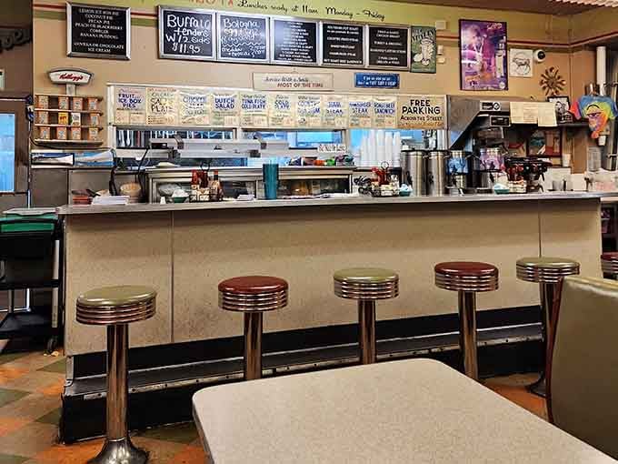 Counter seats offering front-row tickets to the breakfast show, where griddles sizzle and coffee flows endlessly.