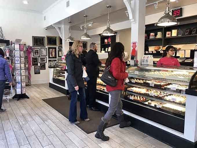 Happy customers contemplating life's toughest decisions: which amazing treat to take home today for dessert tonight.