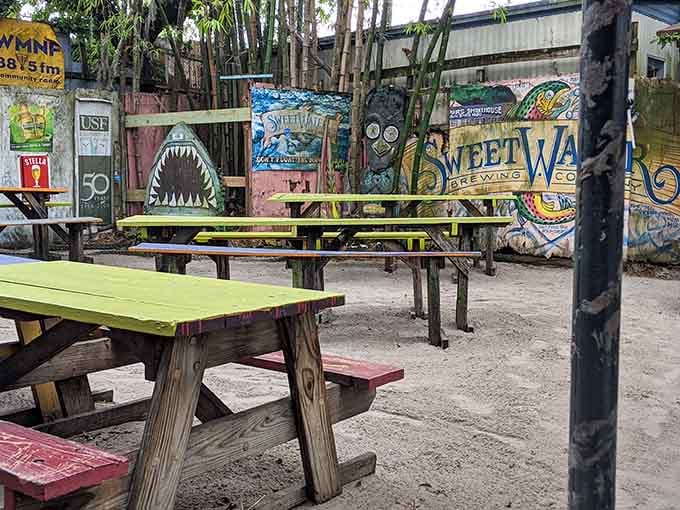 Colorful picnic tables scattered among the palms create the perfect spot for enjoying smoked meats and cold drinks.