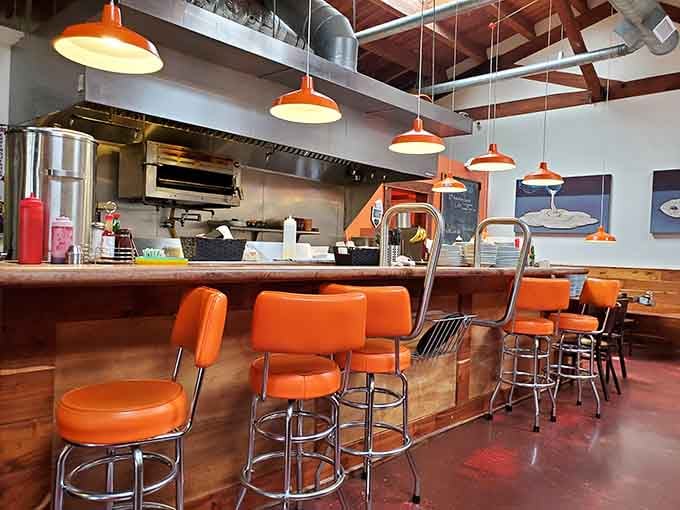 Retro orange stools at the counter offer front-row seats to watch the kitchen magic unfold before your eyes.