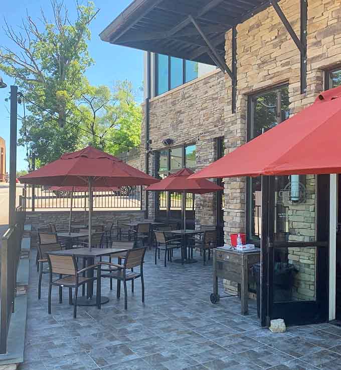 Outdoor patio seating under red umbrellas makes eating barbecue in fresh air feel like a mini vacation.