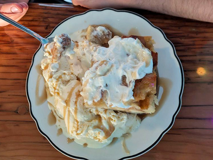 Bread pudding topped with ice cream and caramel, because you absolutely saved room for this masterpiece.