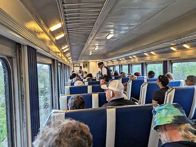 Passengers settle in for the journey, anticipation building as the vintage cars prepare to roll through sugar country.