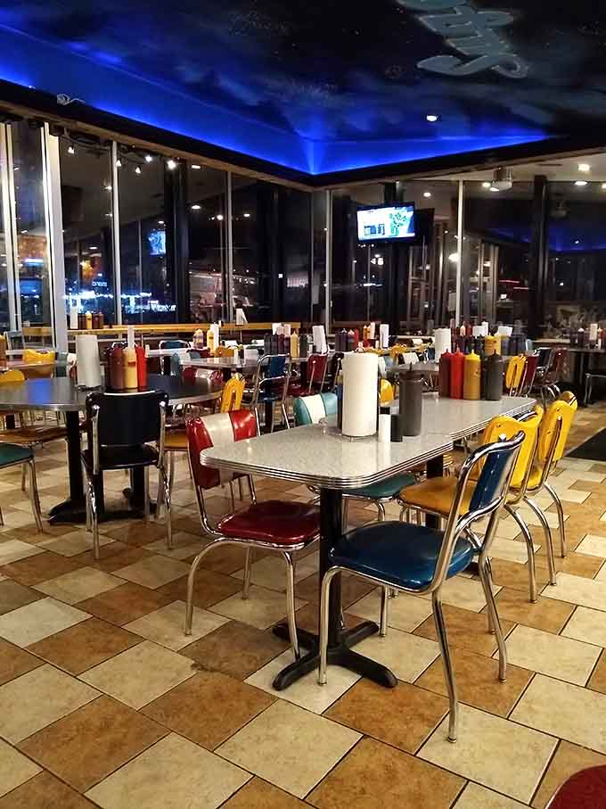 Those colorful retro chairs and dramatic ceiling create an atmosphere where families and friends naturally gather for good times.