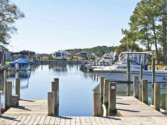 Marina docks reflecting perfectly in still water, creating a scene so serene it could be a meditation app background.