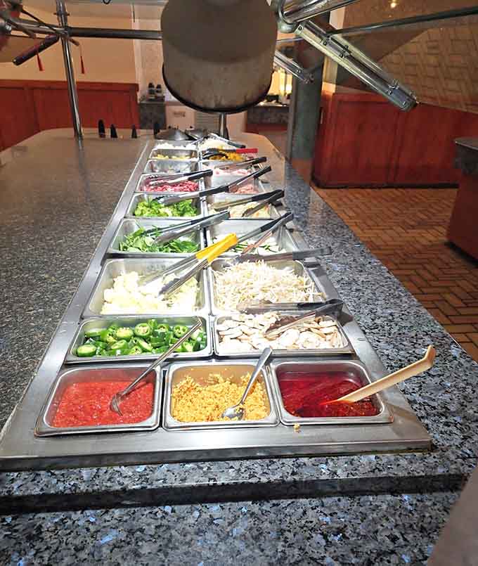 The salad bar offers fresh toppings and sauces for those pretending they're eating healthy between sushi rounds.