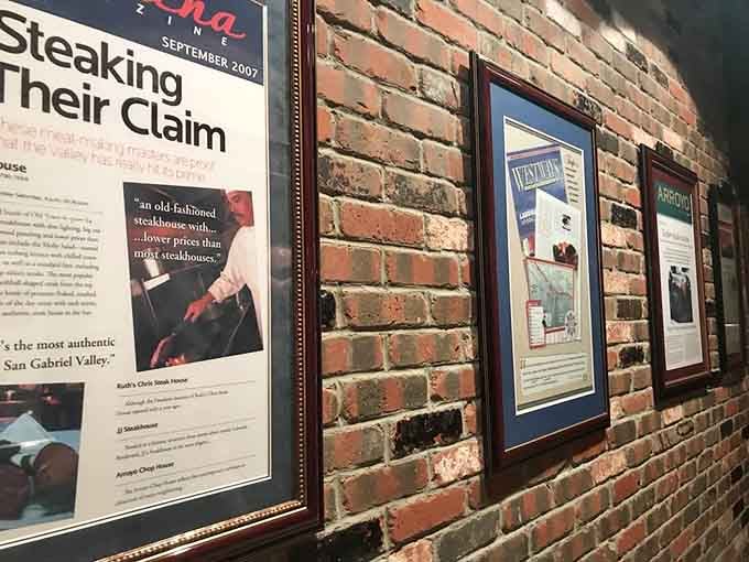 Framed accolades on exposed brick tell the story of a restaurant that's earned its stellar reputation over time.