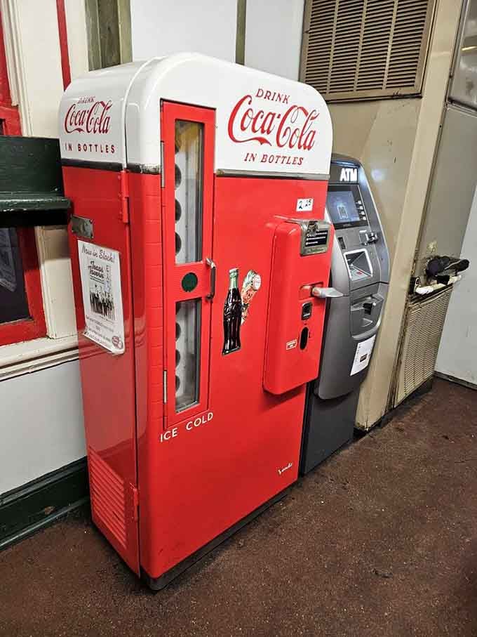 A vintage Coca-Cola machine that's probably seen more late nights than most college students ever will in life.