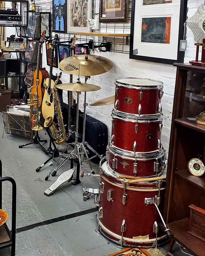 Drums, guitars, and brass instruments create a silent symphony, waiting for musicians to bring them back to life.