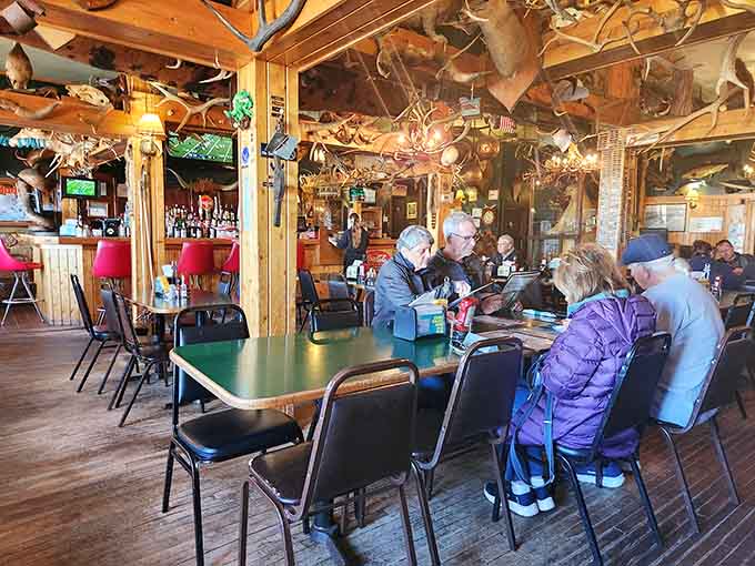 Real diners enjoying real meals under the watchful eyes of mounted moose, which is basically Upper Peninsula dinner theater.