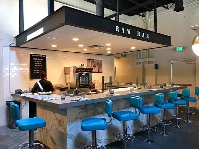 The raw bar beckons with bright turquoise stools, inviting you to belly up for fresh catches.