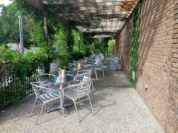 The covered patio where metal chairs and string lights create the perfect setting for long evenings and cold drinks.