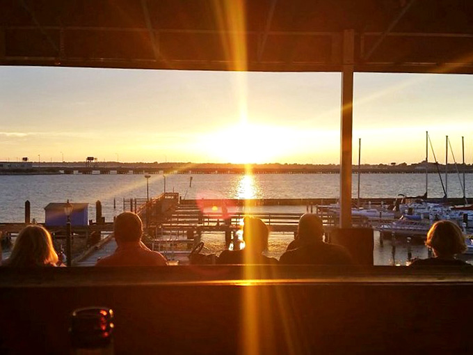 Sunset through the windows transforms dinner into a golden hour spectacle that no Instagram filter could possibly improve upon.