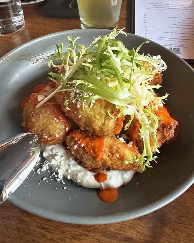 Golden risotto fritters topped with fris&eacute;e prove that fried food can be elegant when treated with respect.