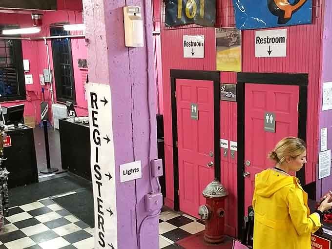 Even the restrooms get the hot pink treatment, maintaining the aesthetic commitment throughout the entire building.