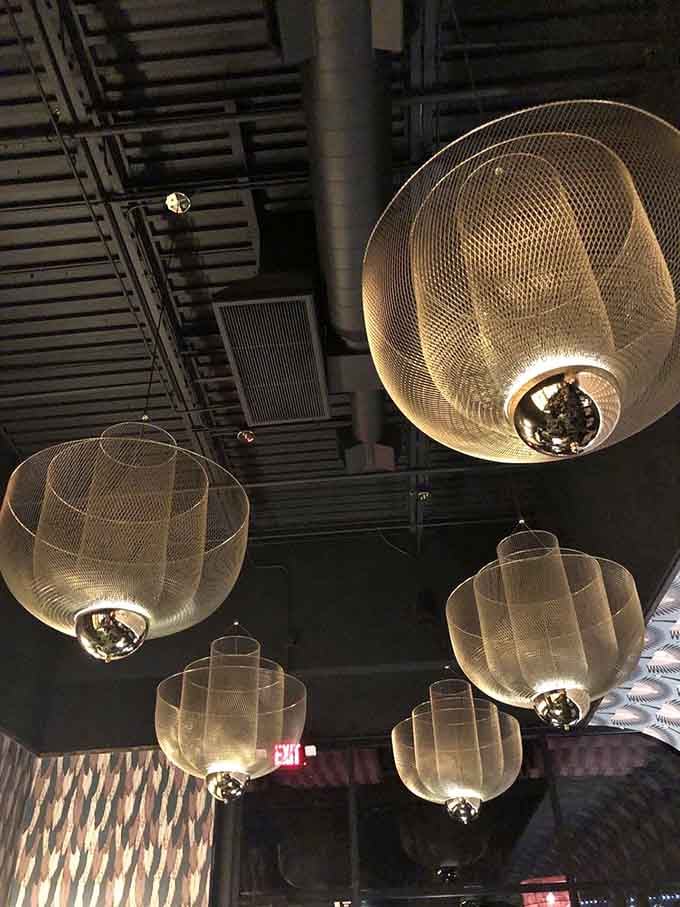 These sculptural light fixtures float overhead like golden clouds, adding drama without stealing the show from below.