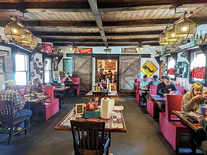 Happy diners enjoying their meals in pink booths, living their best barbecue life right now.