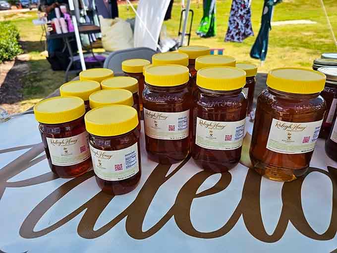 Golden honey jars catch the sunlight, sweet liquid gold from local bees doing their important environmental work.
