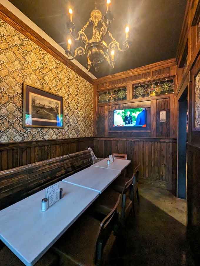 A private dining room with ornate wallpaper and a chandelier, because sometimes you need fancy with your fish.