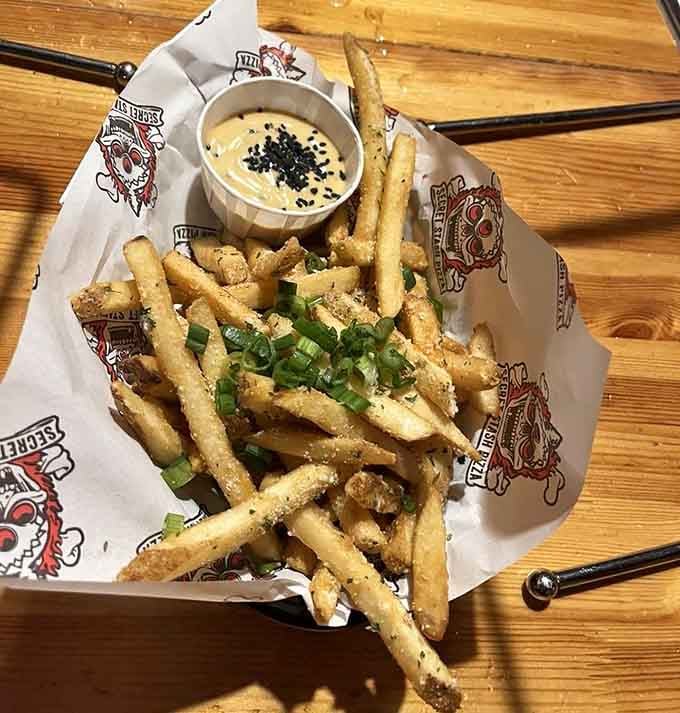 These aren't ordinary fries; they're seasoned, topped, and served with sauce that justifies the addictive nickname.