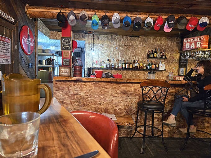 The bar area lined with cowboy hats and Western charm, where locals gather and travelers become temporary regulars.
