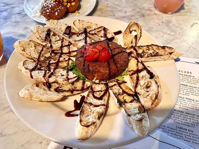 Goat cheese surrounded by toasted bread like edible flower petals, because presentation absolutely matters when you're eating art.
