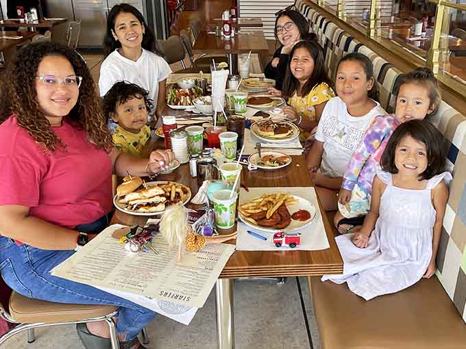 Families gathering around tables piled with food, creating memories one pancake stack at a time.