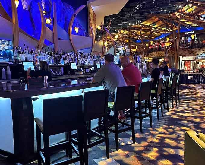 The bar stretches invitingly, offering liquid courage before you tackle that impressive wine list selection.