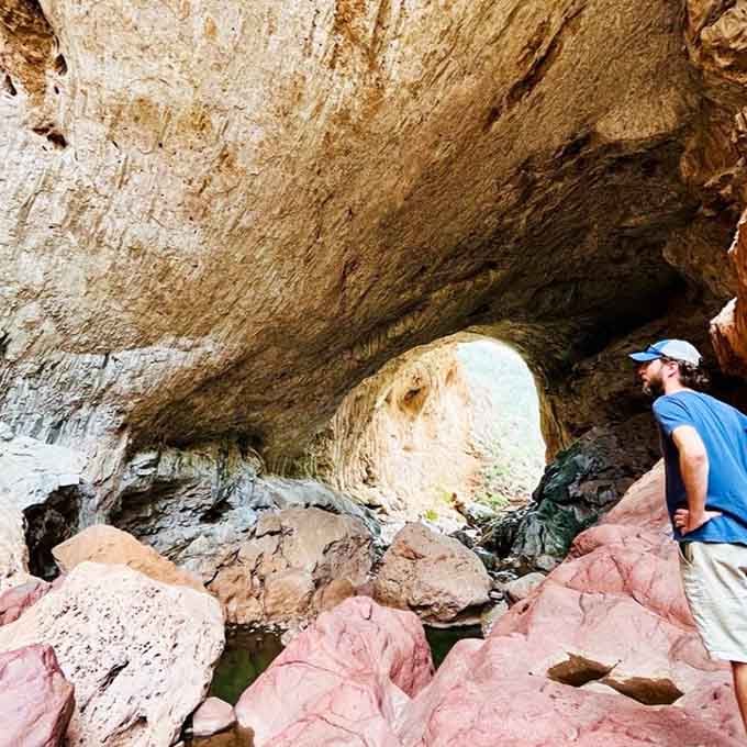 Inside the tunnel, travertine ripples create texture that looks almost like frozen waves of honey-colored stone.
