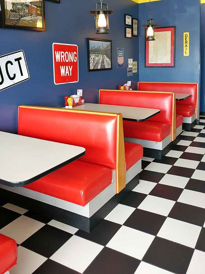 Bright red booths and vintage railroad signs create the perfect backdrop for family dining adventures.