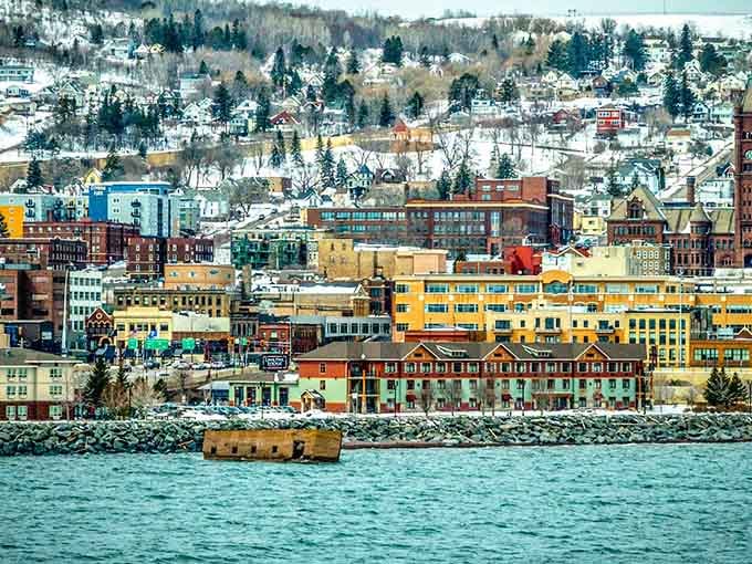 The colorful buildings of Duluth watch from shore, probably wondering when their concrete neighbor will finally get its act together.