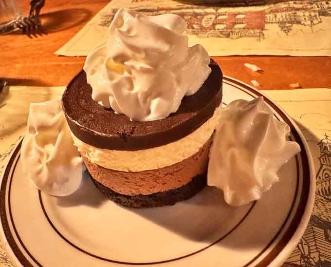 Dessert arrives looking like a chocolate lover's fever dream, complete with clouds of whipped cream.