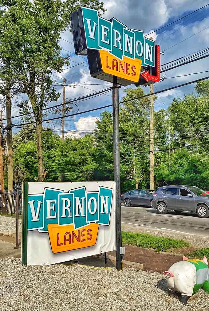 That classic roadside sign beckons like a beacon of simpler times when entertainment meant actually leaving the house.