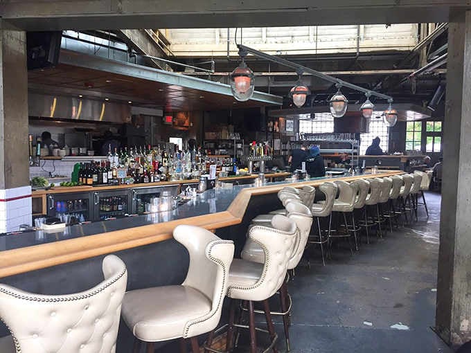The long bar with comfortable seating invites you to settle in for drinks and conversation.