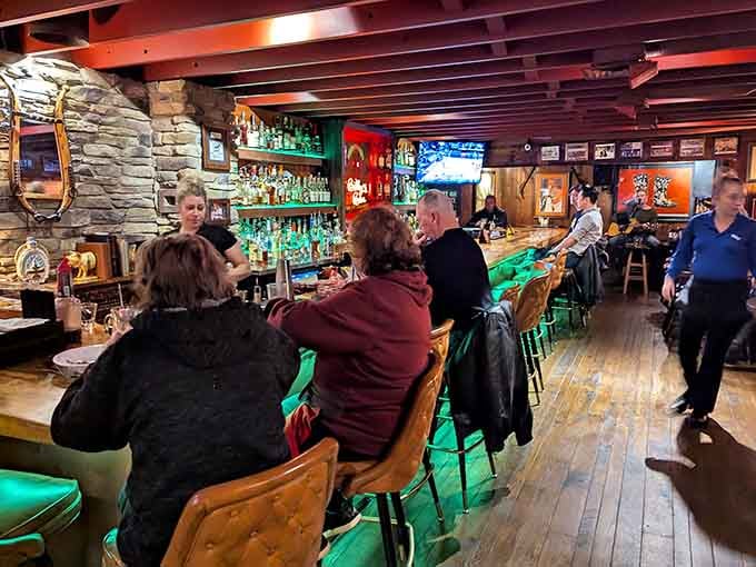 Happy diners at the bar enjoying good company, cold drinks, and the anticipation of excellent food.