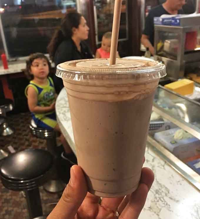 A chocolate shake so thick your straw stands at attention, ready to deliver creamy, cold happiness with every sip.